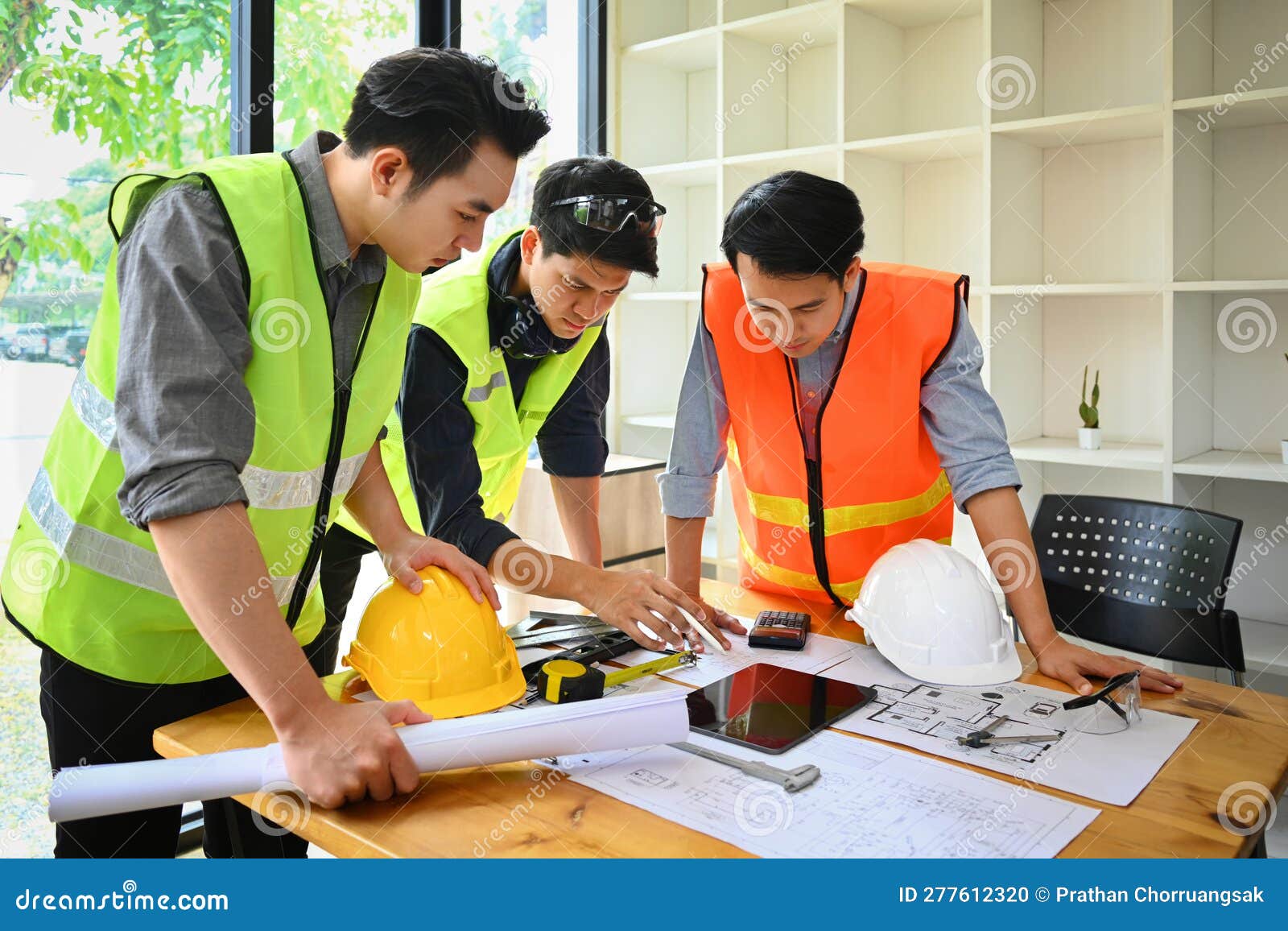 Architects Team Working with Blueprints, Discussing and Planning ...