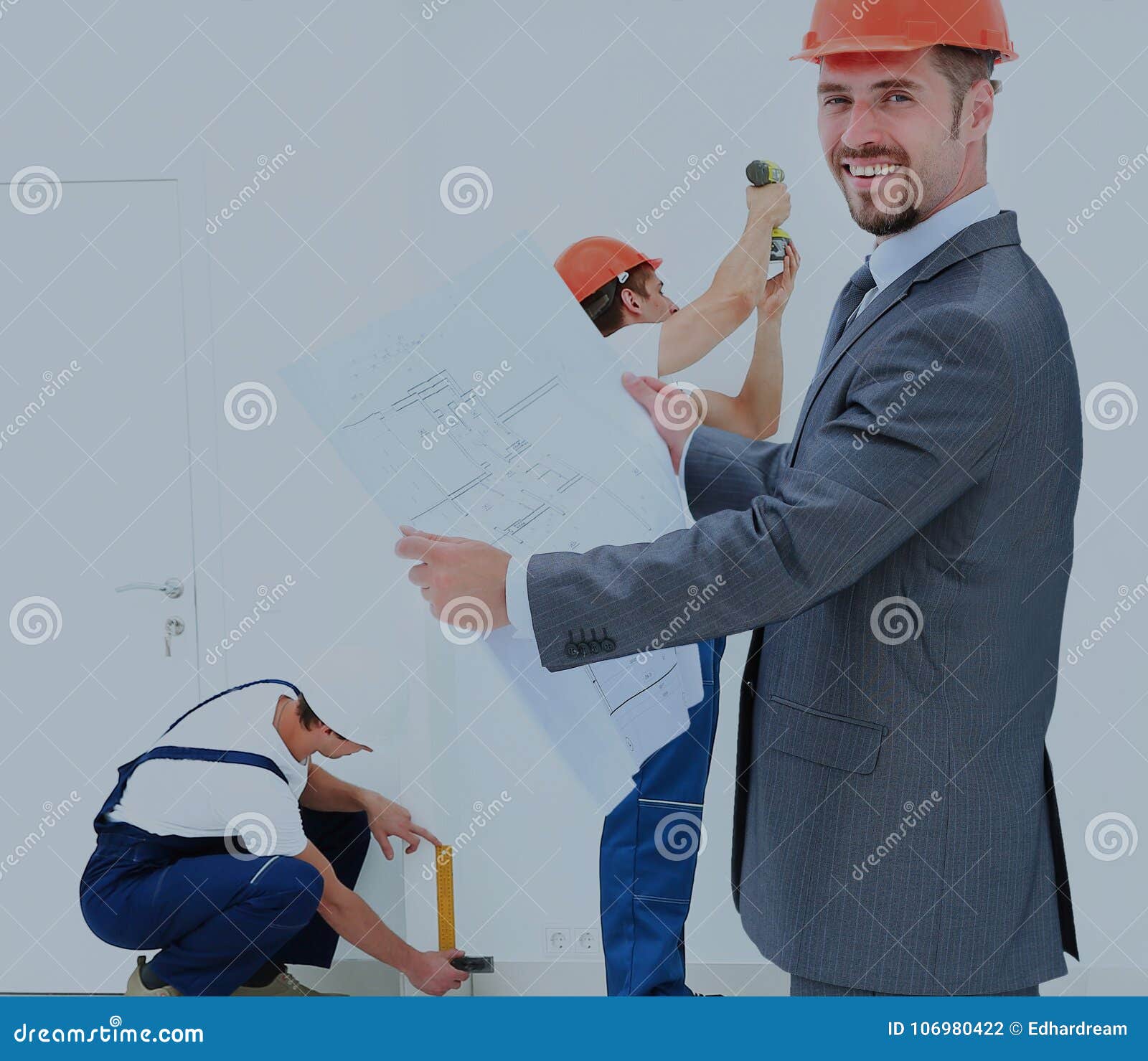 Engineer Studying Blueprints Against the Backdrop of a Team B Stock ...