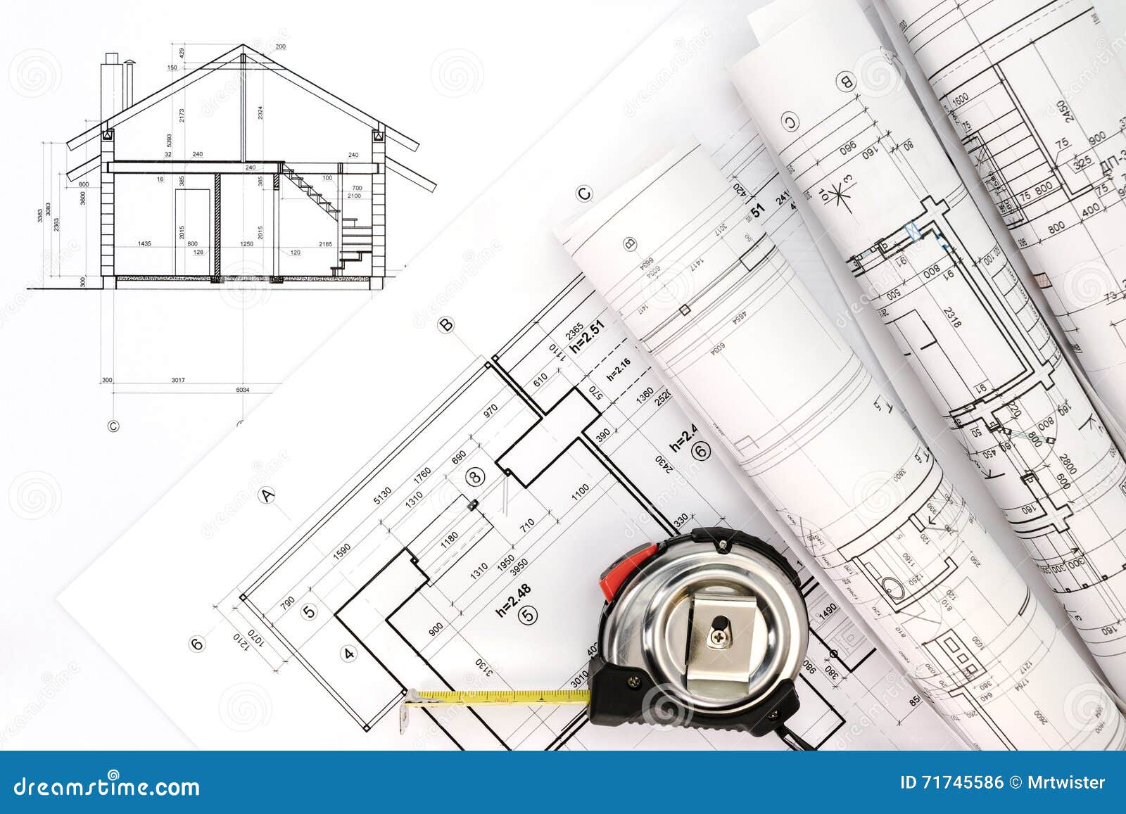 Architects Workspace with Rolls of Plans and Tape Measure Stock Photo ...