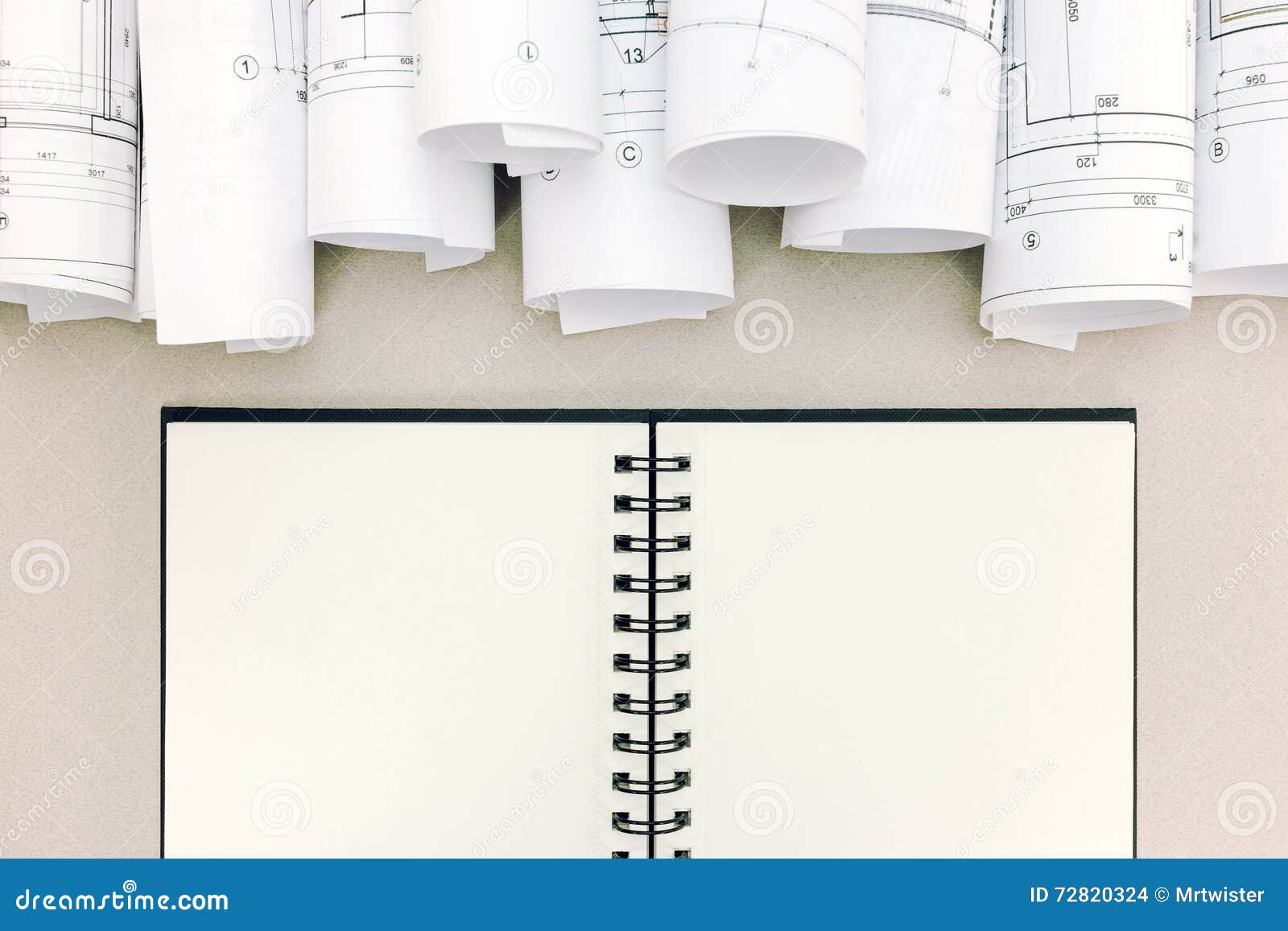 Architectural Blueprint Rolls and and Notepad on Table Stock Photo ...
