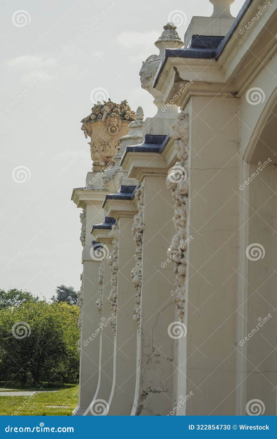 A Row of Architecturally Designed Columns with Trees and Sky in ...