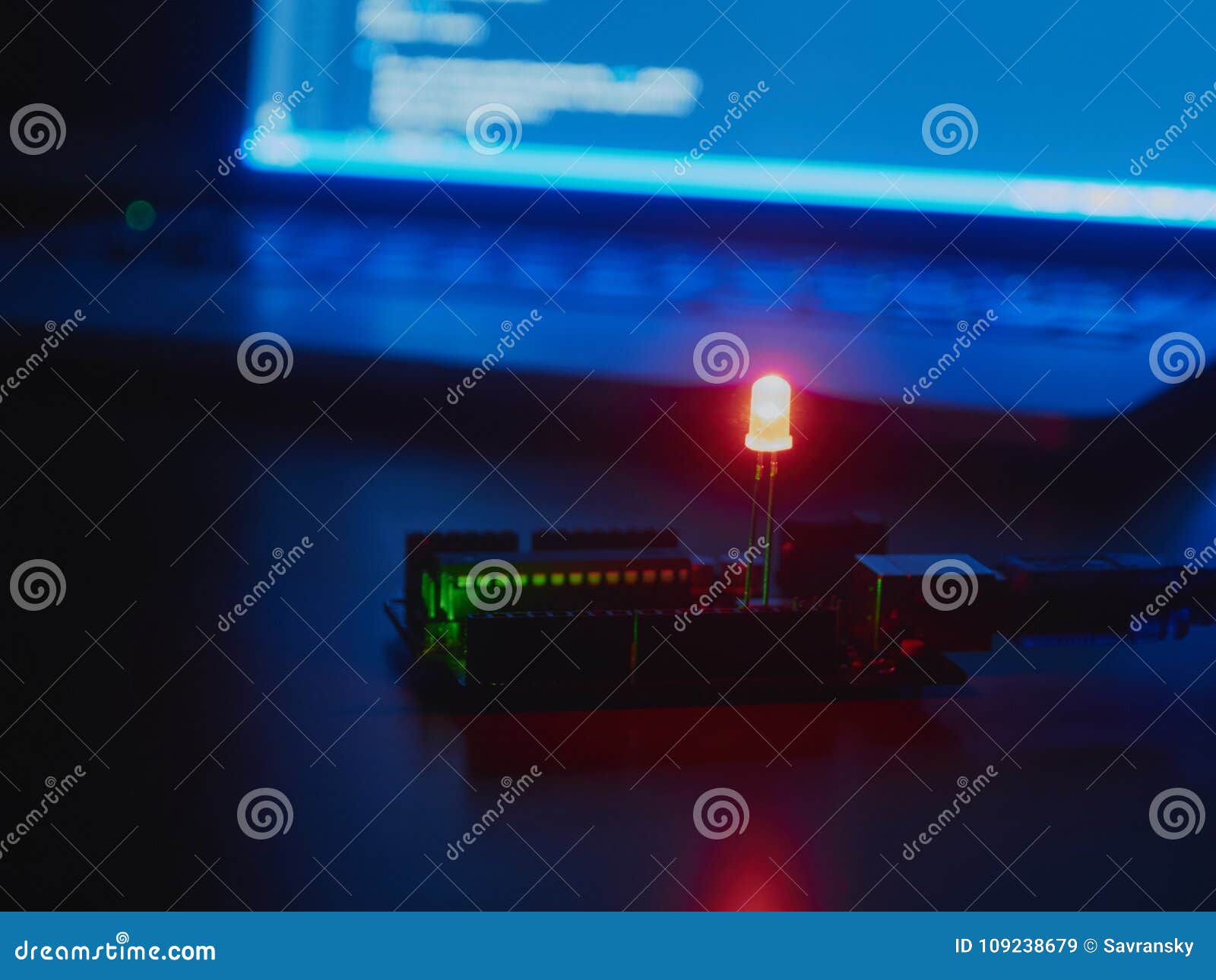 Arduino with Red Light-Emitting Diode Against a Laptop Screen Stock ...