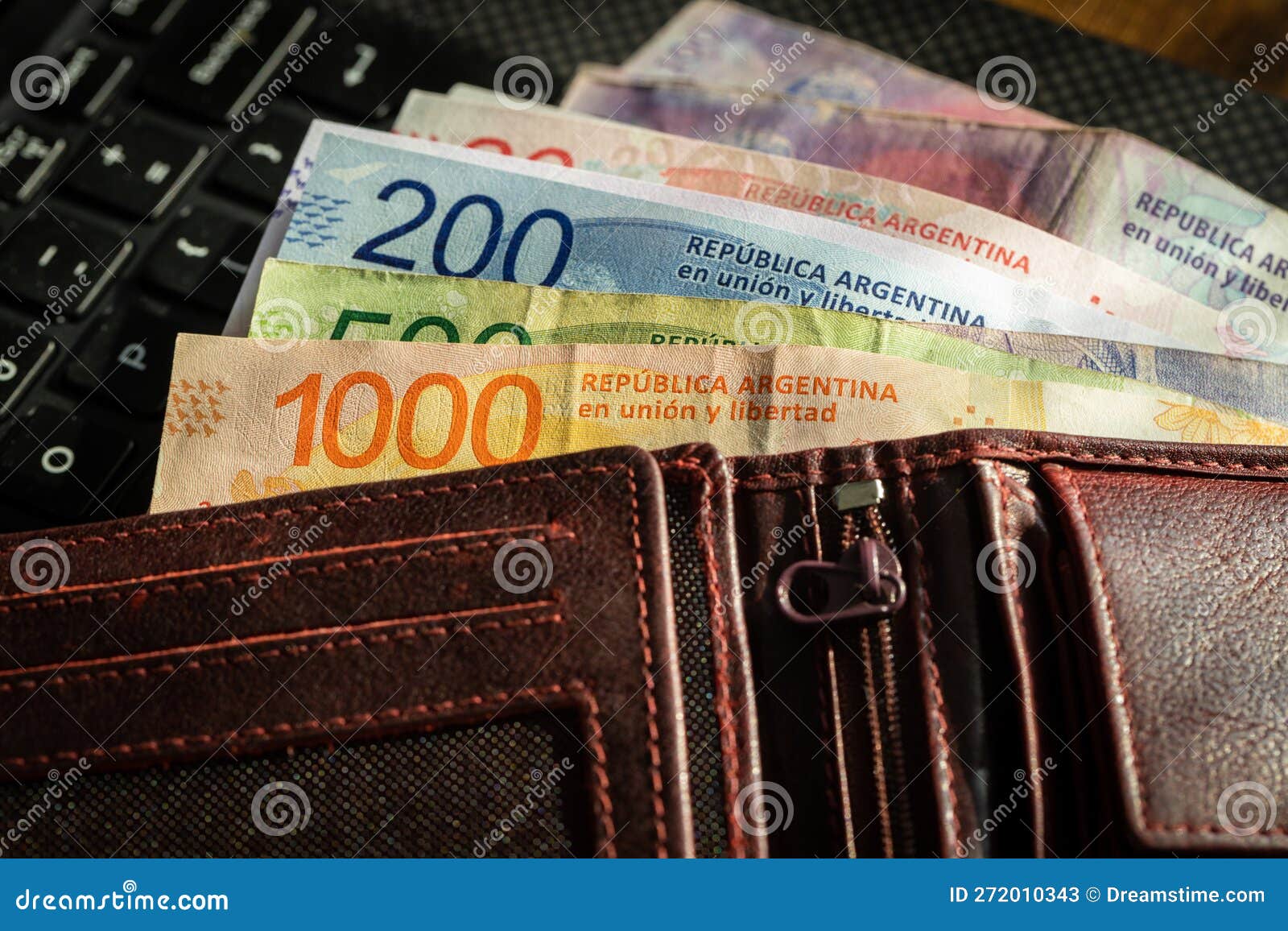 Argentine Pesos, a Wallet with Money Lying on a Computer Keyboard Stock ...