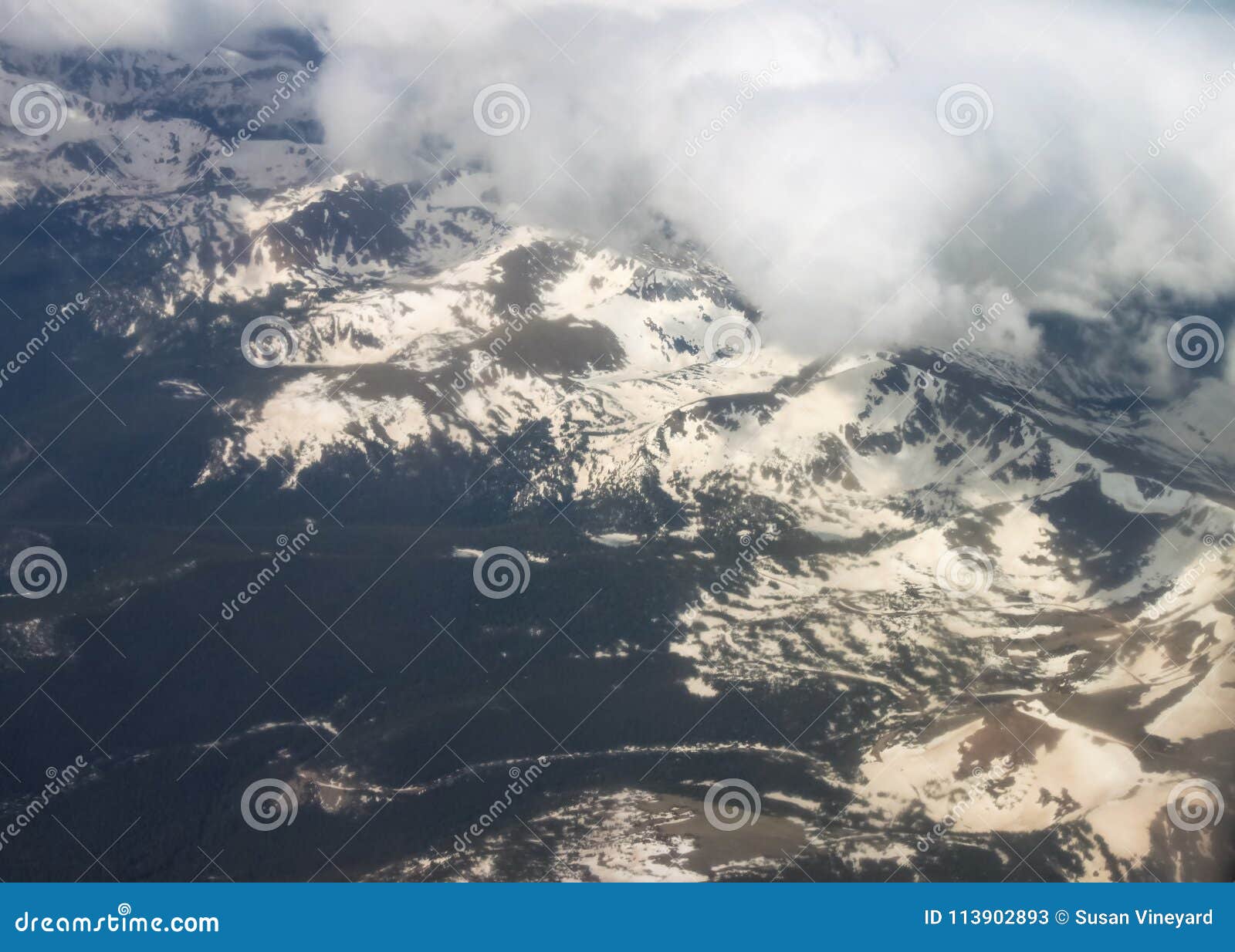 Arial View Looking Down on Snow Covered Mountains Shrouded with Fog ...