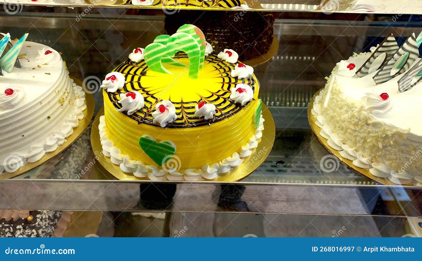 Arious Cake with Icing in Refrigerated Bakery Case Cabinet - Image ...