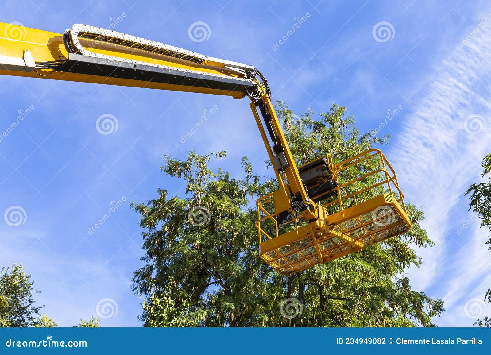 Arm of High Lift Platform on the Top of the Trees and Blue Sky. Tree ...