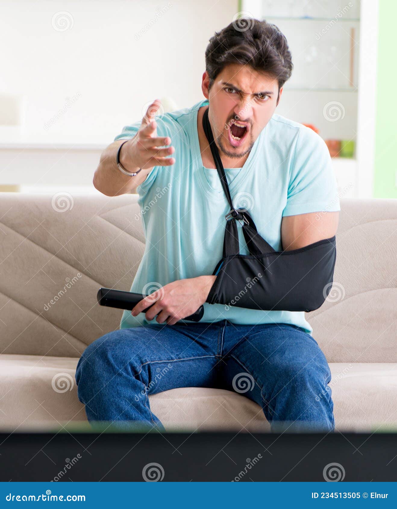 Arm Injured Man Sitting on the Sofa Watching Tv Stock Image - Image of ...