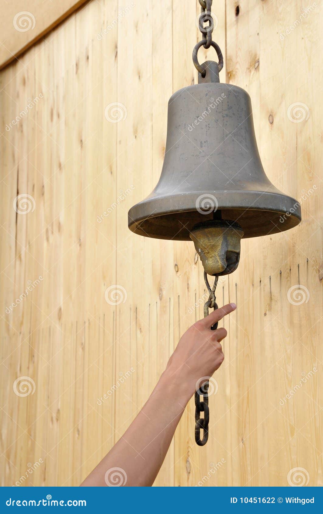 Arm ringing a bronze bell stock photo. Image of wooden - 10451622