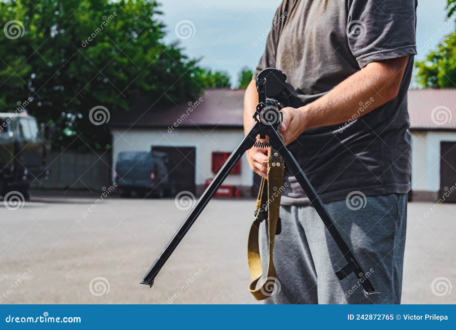 Armed Man with a Sniper Machine Gun Military Weapon in the Hands of a ...
