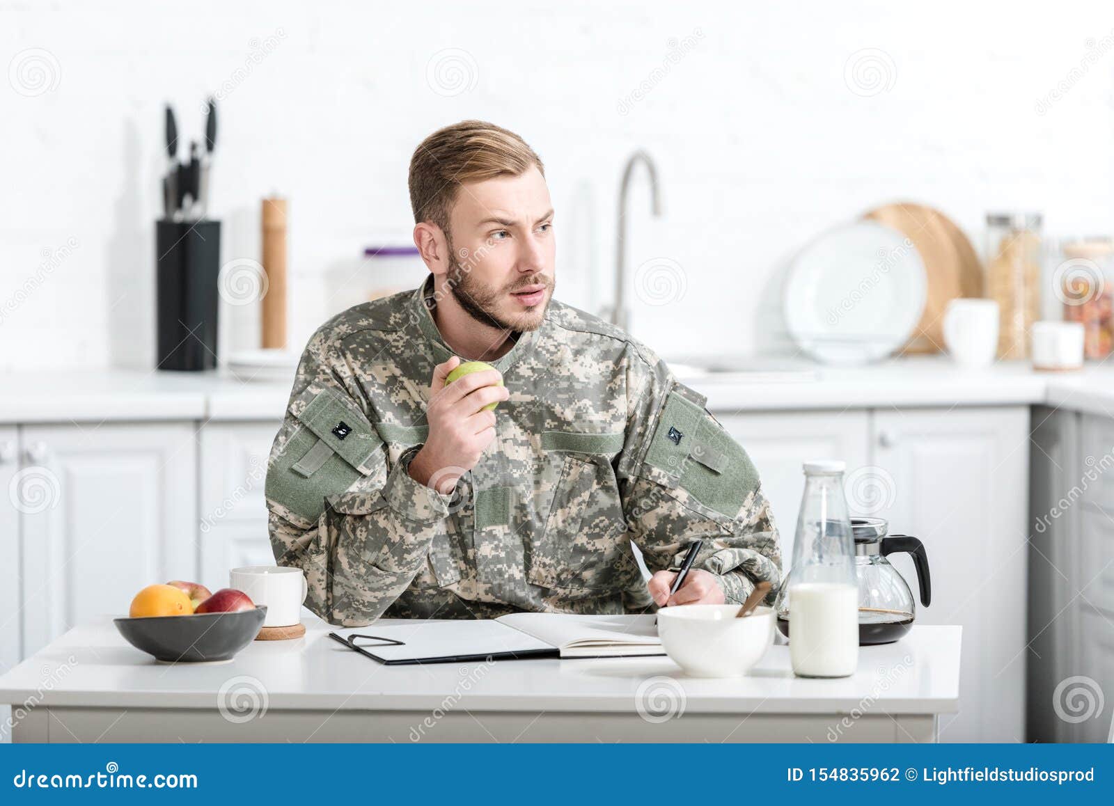 Army Soldier Sitting at Kitchen Table and Stock Photo - Image of ...