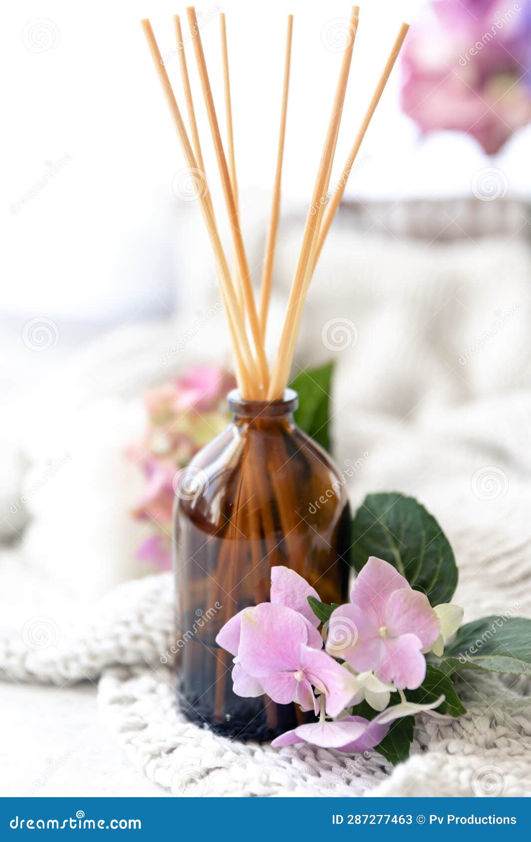 The Aroma Diffuser with the Stick Perfume and Flowers on a Blurred ...