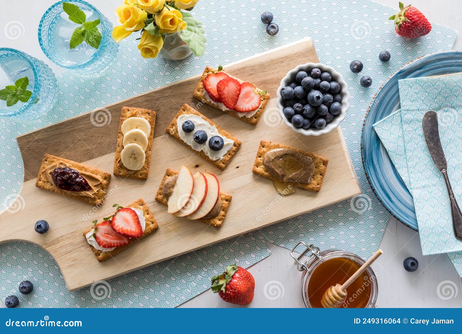 An Array of Breakfast Crackers with a Variety of Toppings on a Wooden ...