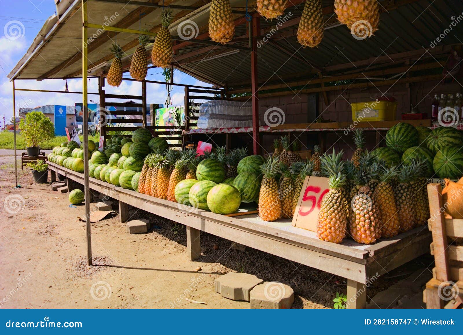 A Display of Pineapples, Melons and Other Fruit on Top of Tables Stock ...