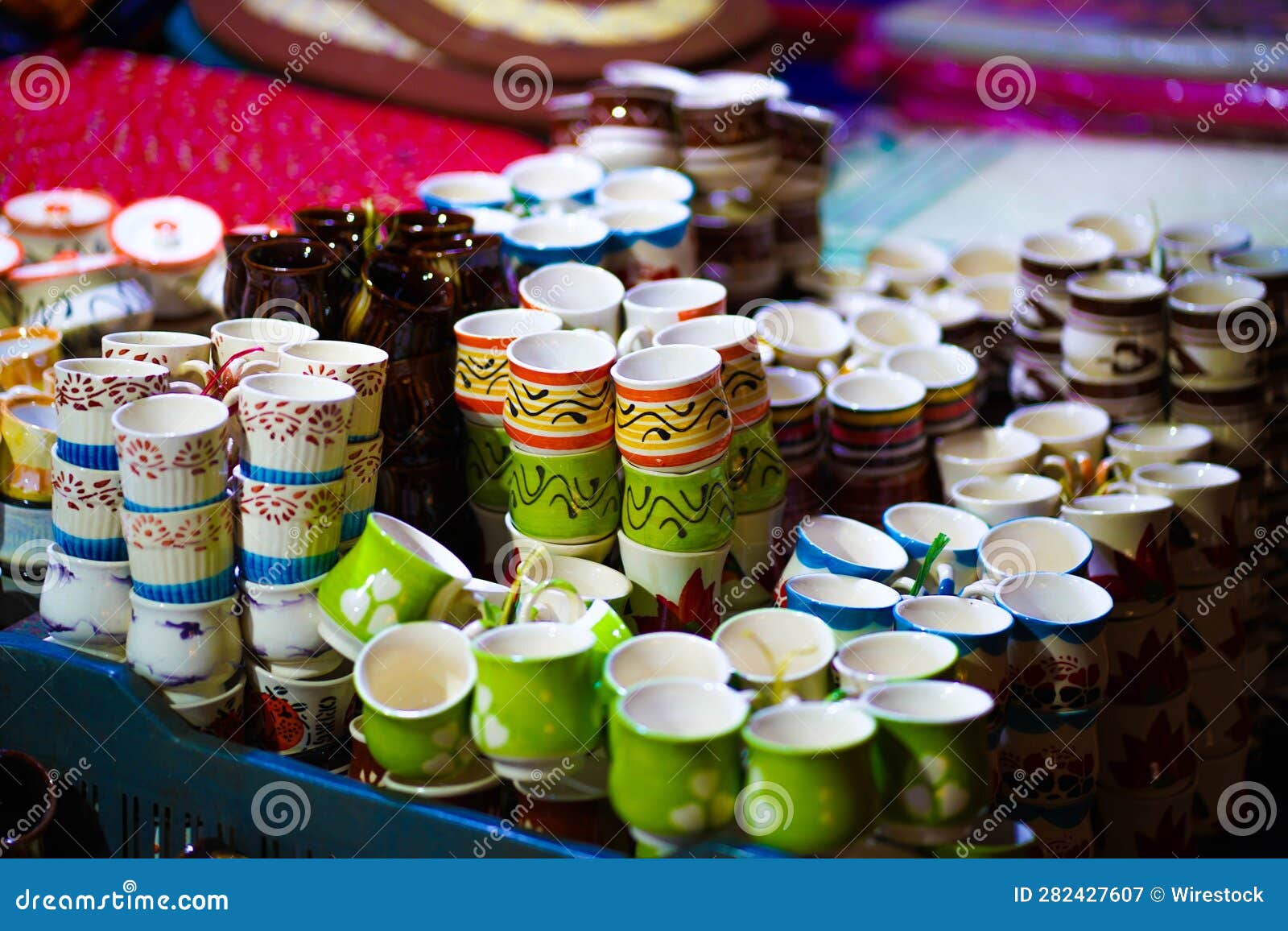 Many Different Colored Cups are Placed on the Table Together with Each ...