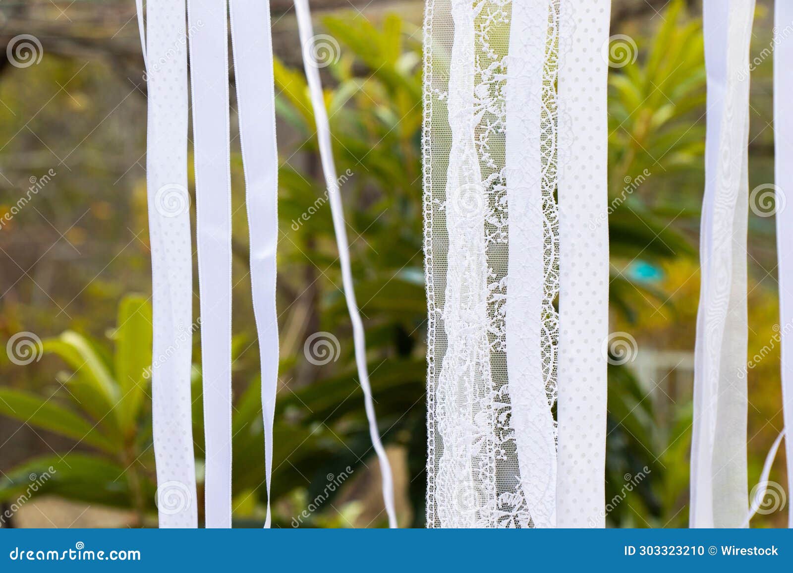 Array of White Lace Strips Hanging in a Garden Stock Photo - Image of ...