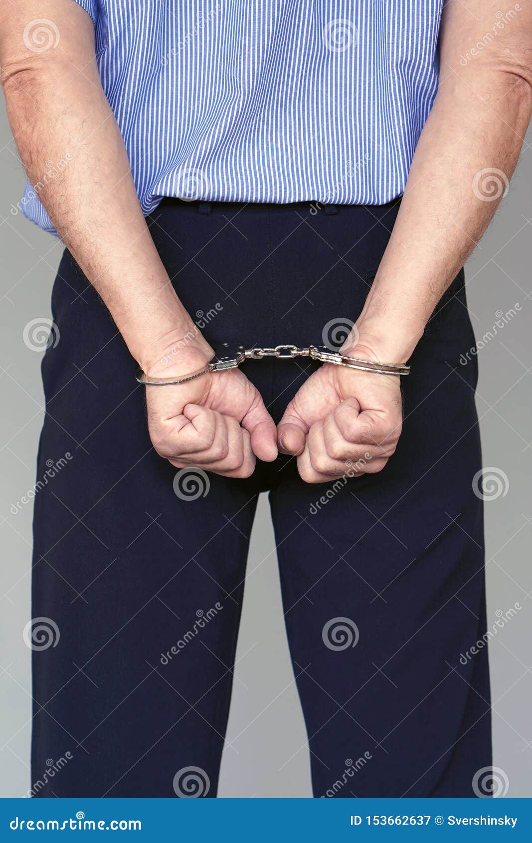 Criminal Hands Locked in Handcuffs. Close-up View Stock Image - Image ...