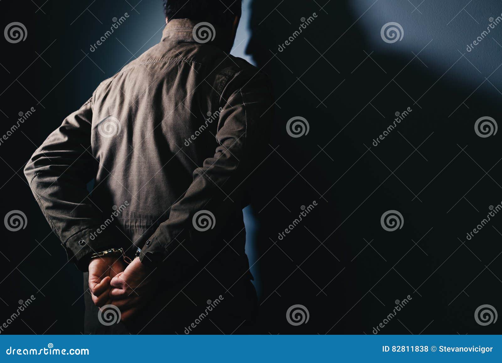 Arrested Male Criminal with Handcuffs Facing Prison Wall Stock Photo ...