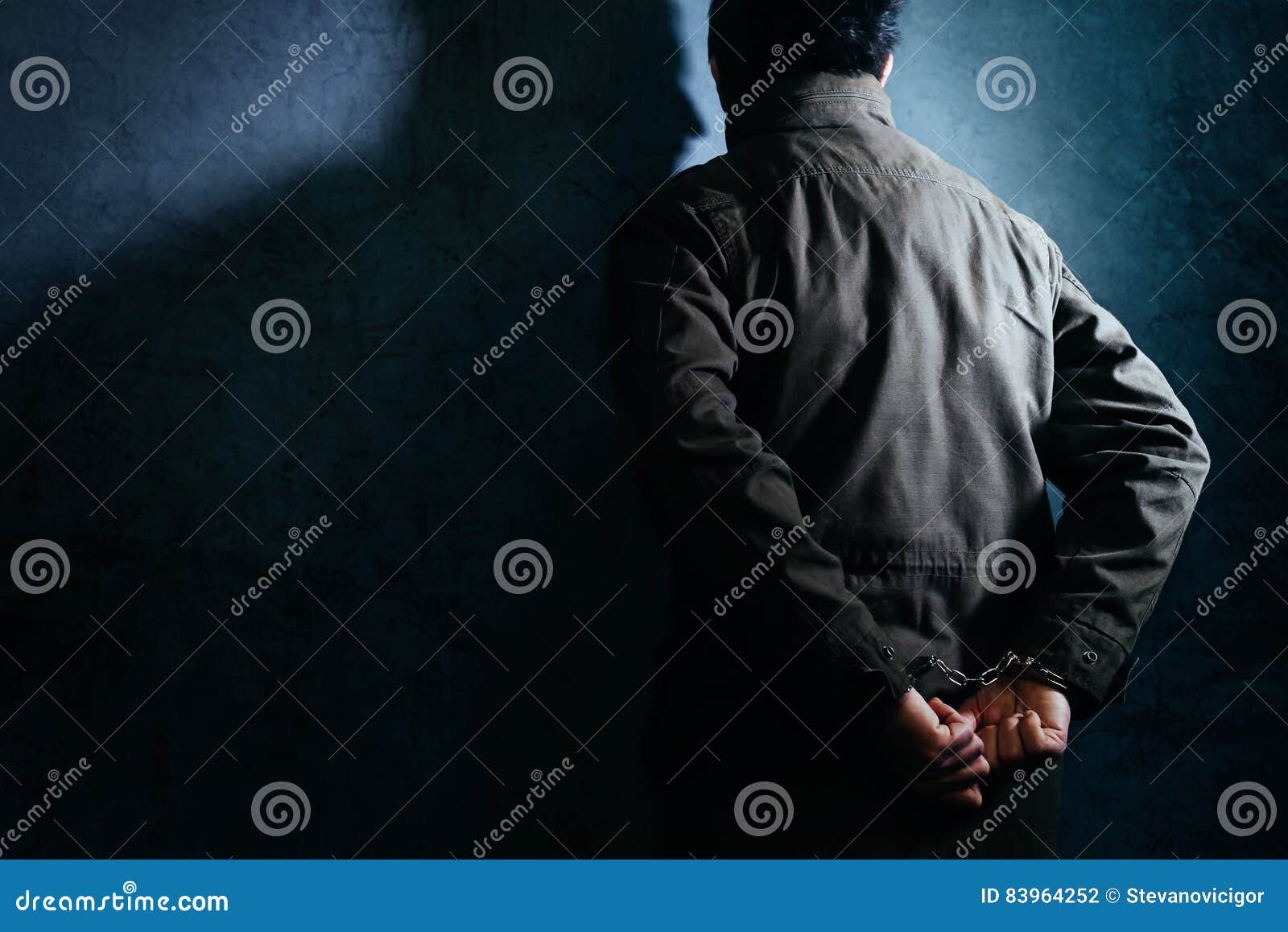 Arrested Male Criminal With Handcuffs Facing Prison Wall Stock Photo ...
