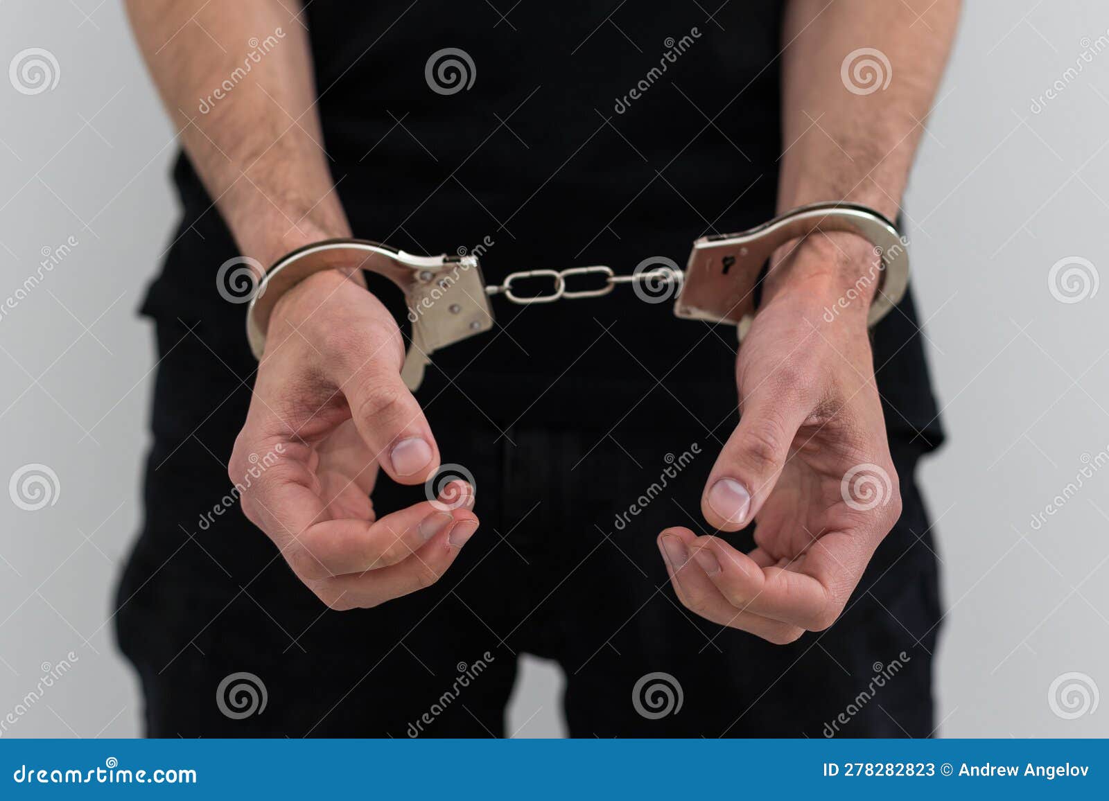 Arrested Man with Cuffed Hands Behind Prison Bars. Stock Image - Image ...