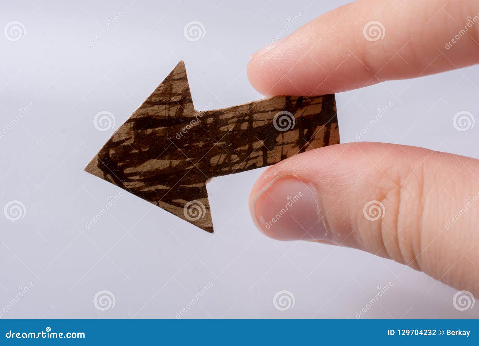 Arrow Cut Out of Brown Paper in Hand Stock Photo - Image of creative ...
