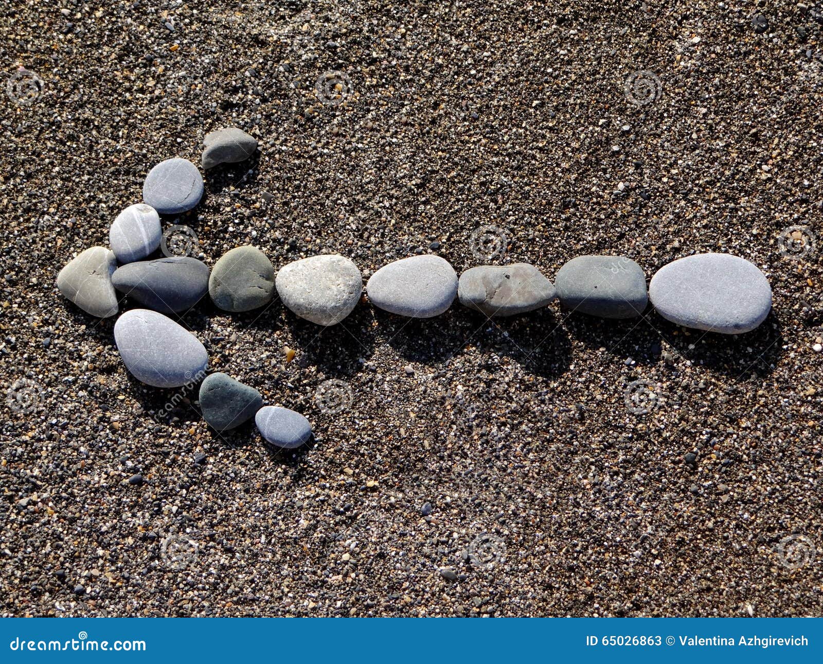 Arrow of Stones in the Sand Stock Image - Image of rocks, grey: 65026863