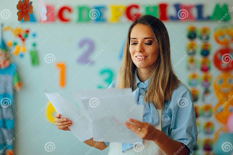 Teacher Holding Paperwork Assignments from Students Stock Photo - Image ...