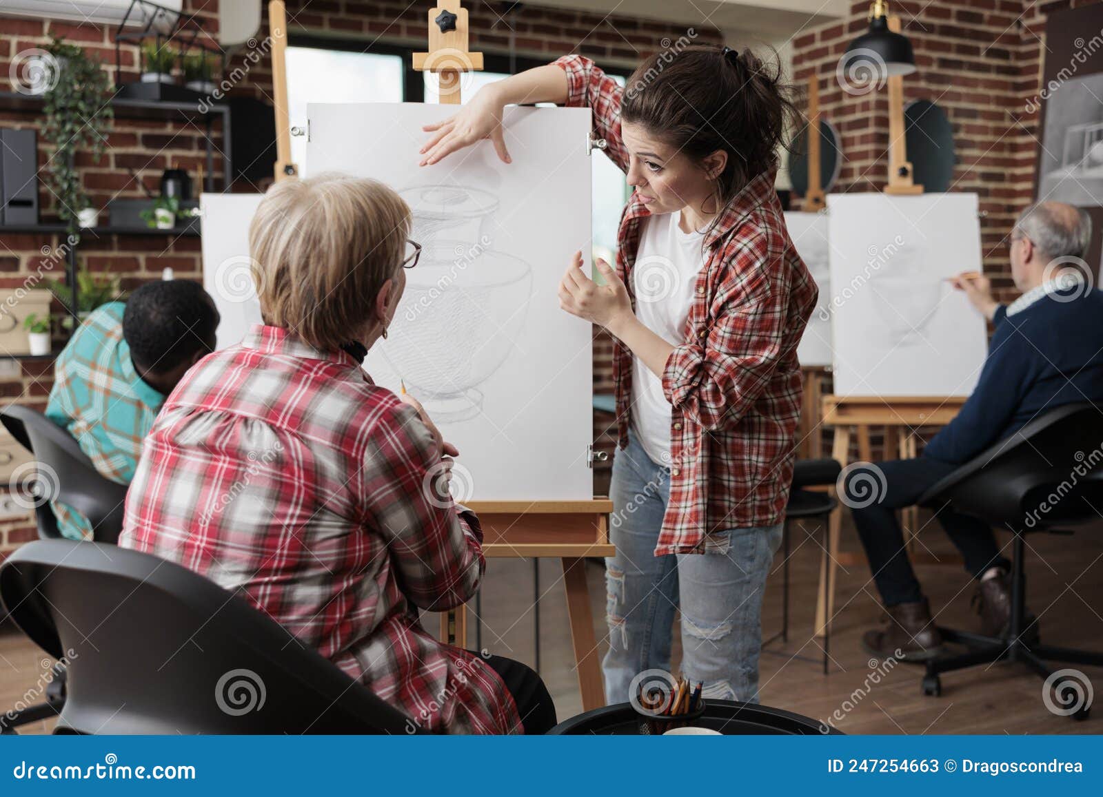 Art Teacher Helping Senior Student To Develop Sketching Technique Stock ...