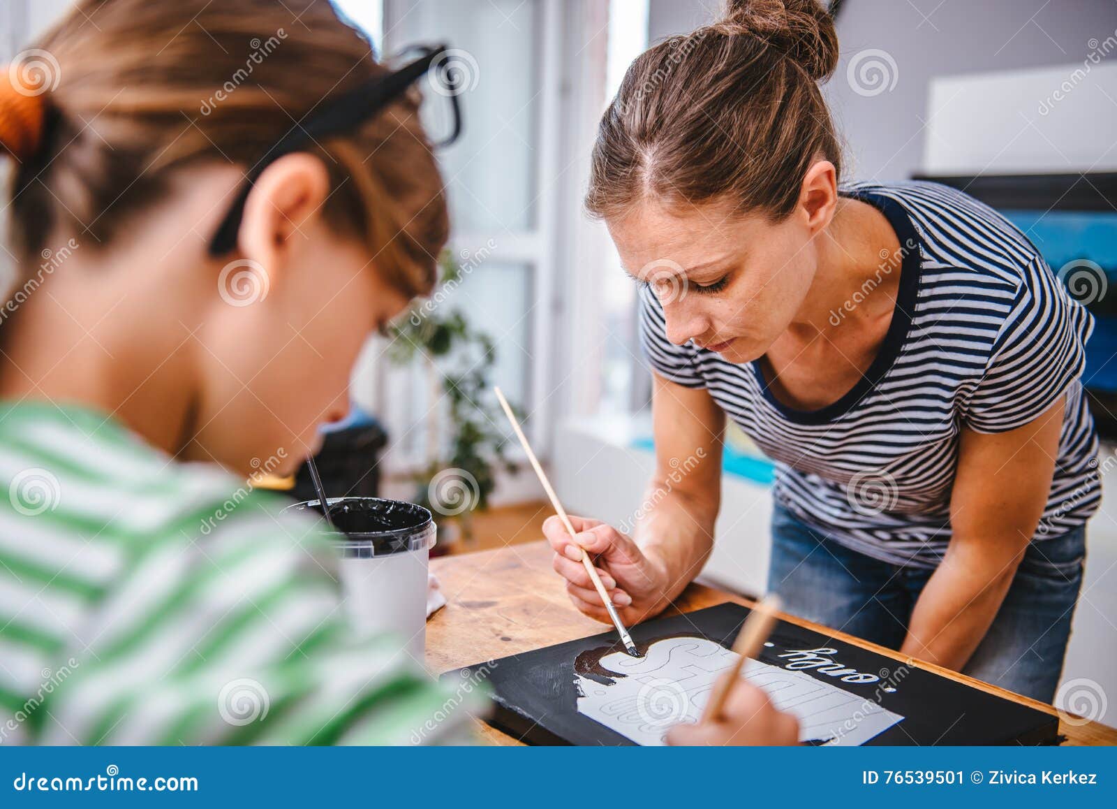 Art Teacher Helping a Student with Painting Stock Image - Image of ...