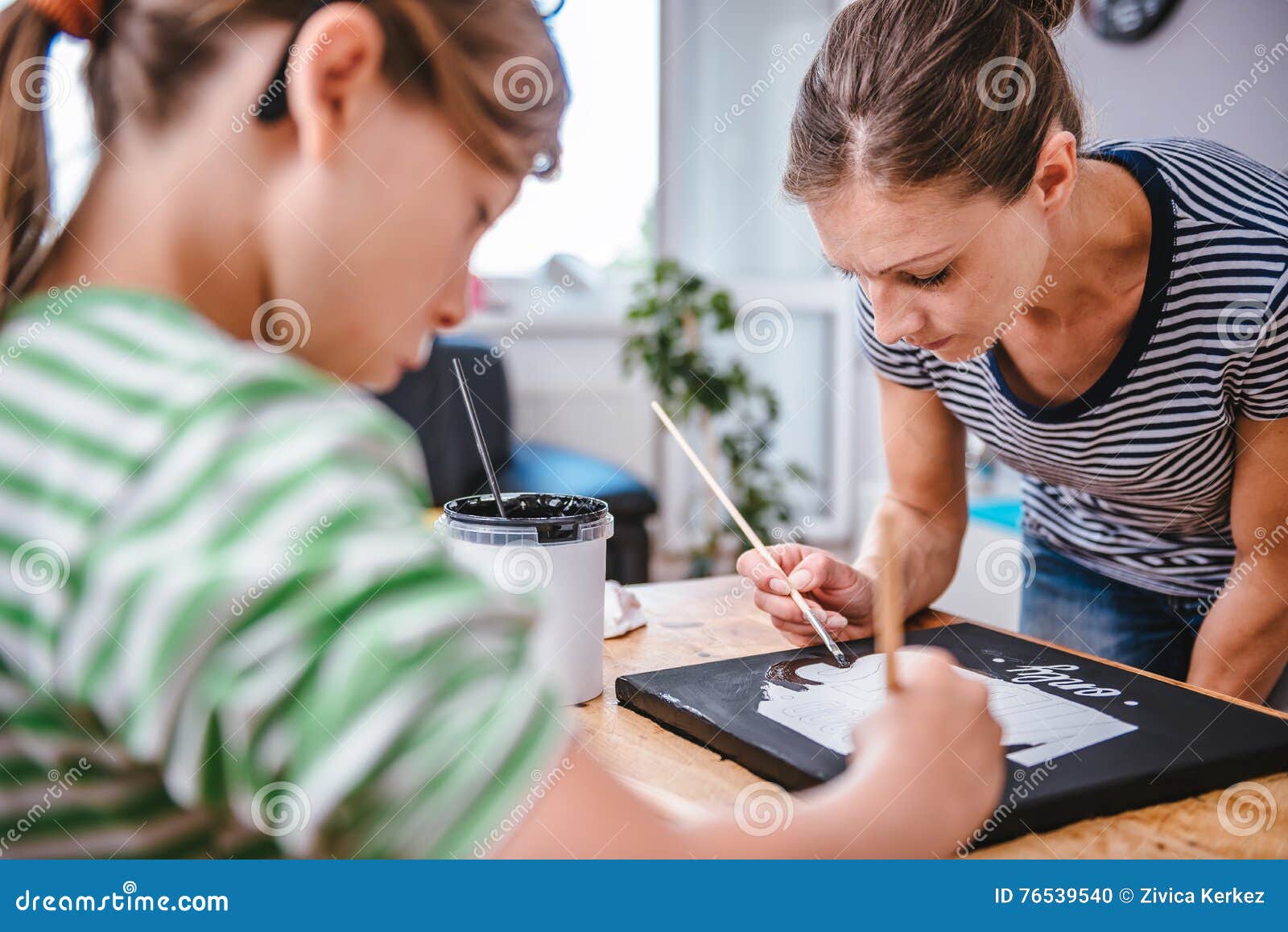 Art Teacher Helping a Student with Painting Stock Photo - Image of ...