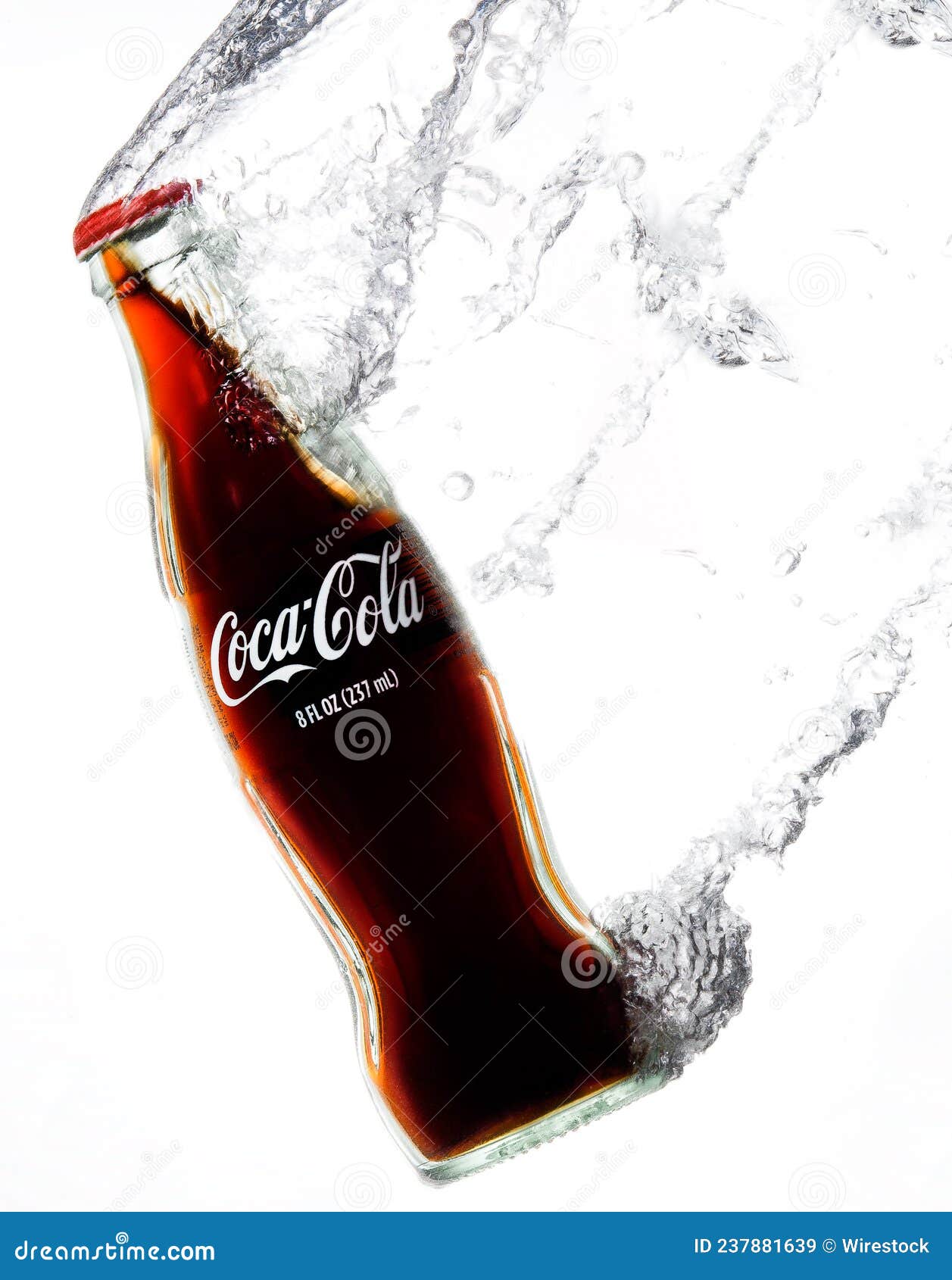 Vertical Closeup of the Classic Coca-Cola Bottle Swooshing Under Water ...