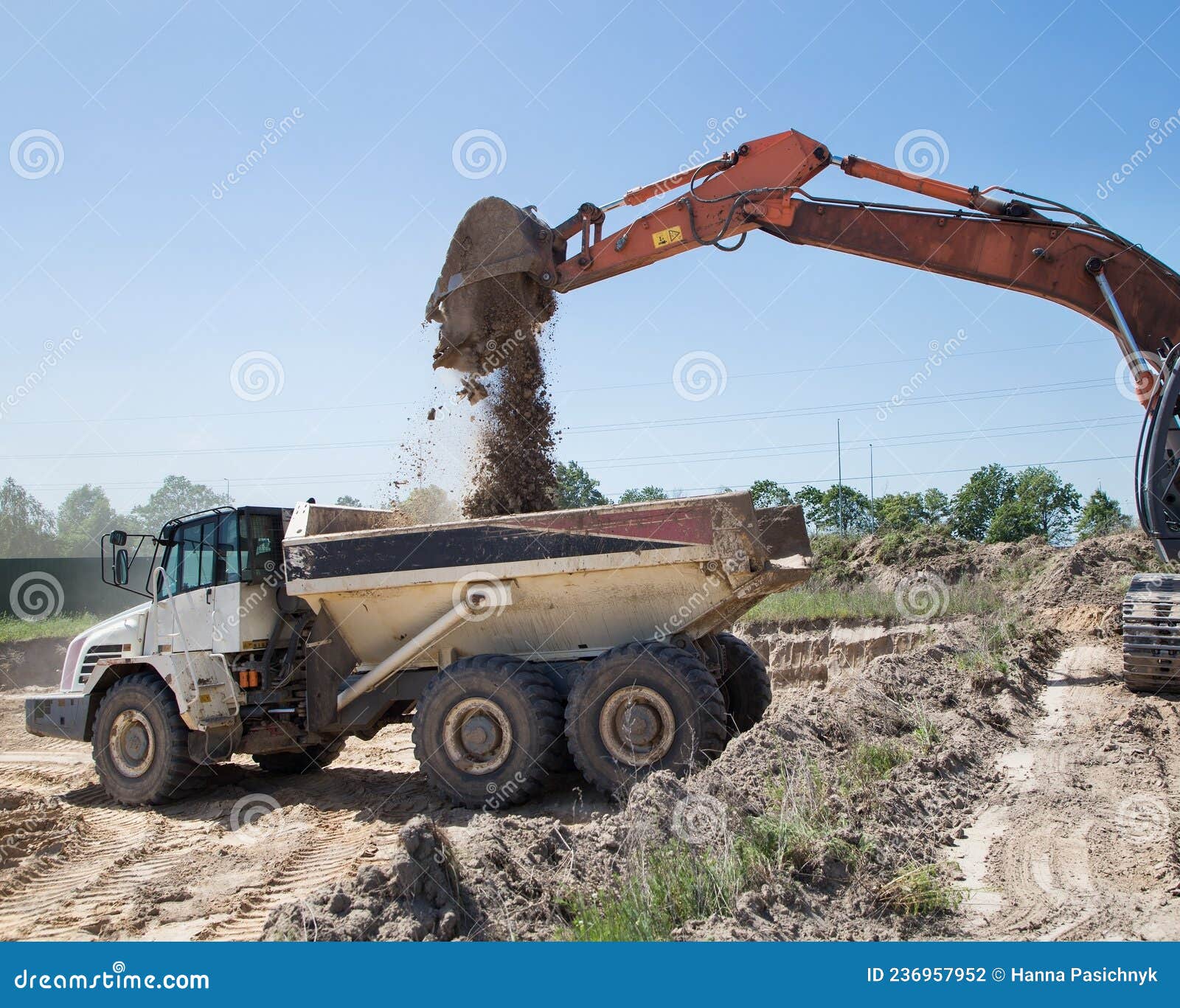 Articulated Dumper at a Construction Site during Loading and ...