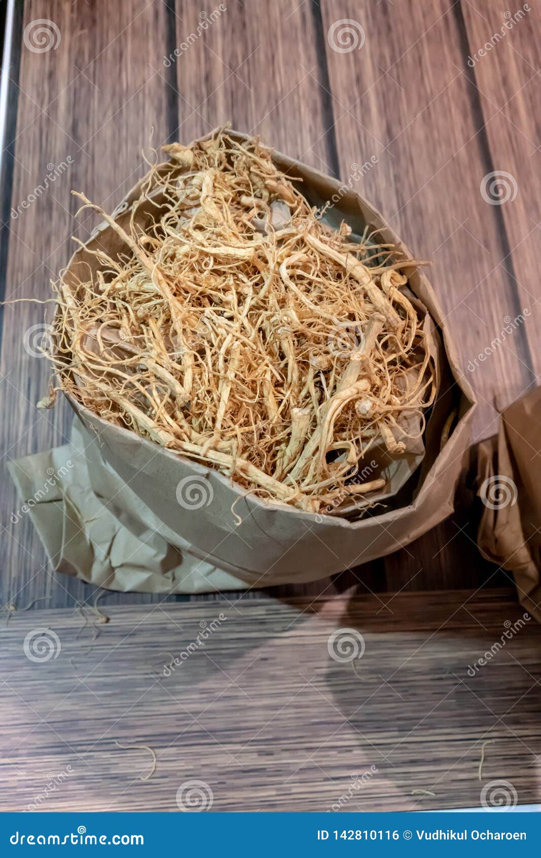 Artificial Dried Finger Root in Craft Paper Sack on Wooden Background ...