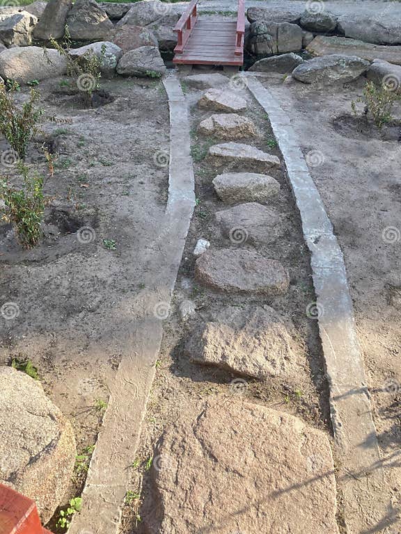 An Artificial Pathway with Irregular Rock Borders, Set Amidst a Wet ...