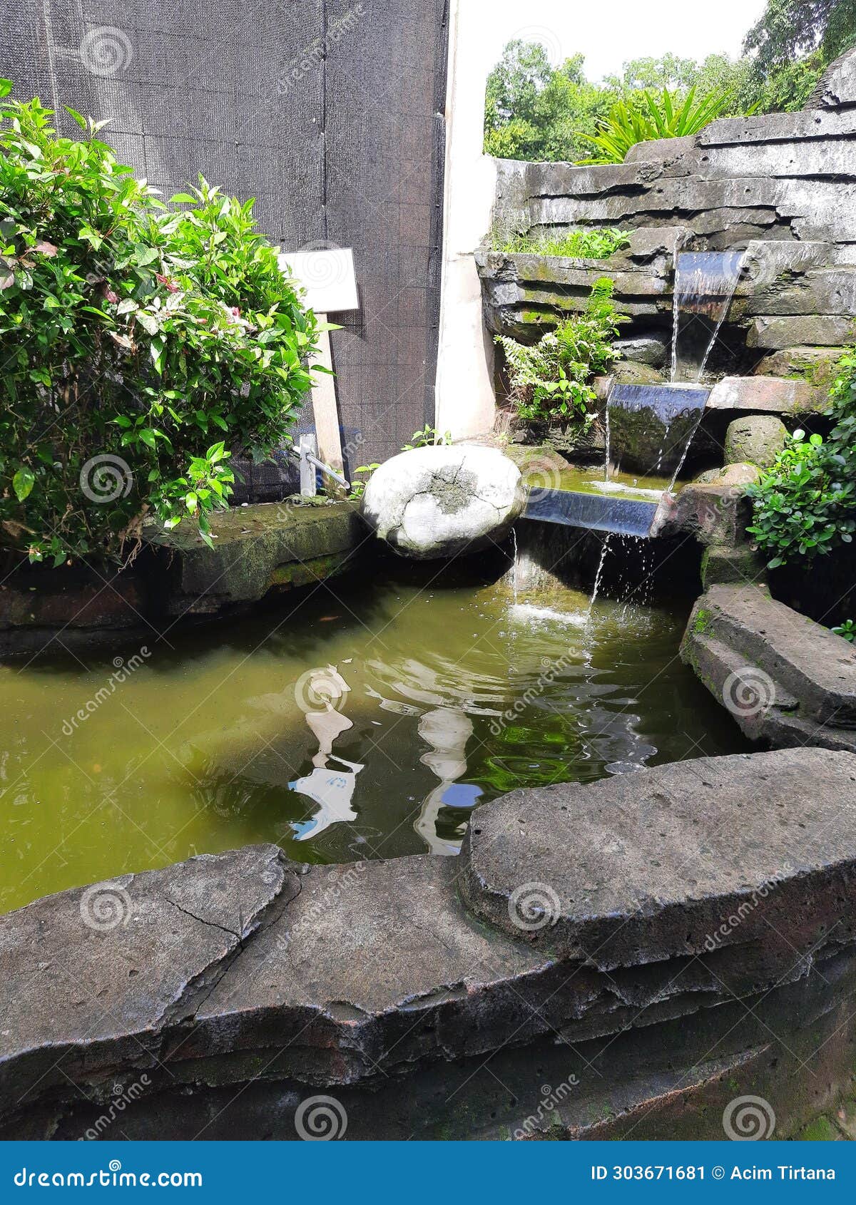 An Artificial Waterfall is Above the Fish Pond Stock Image - Image of ...