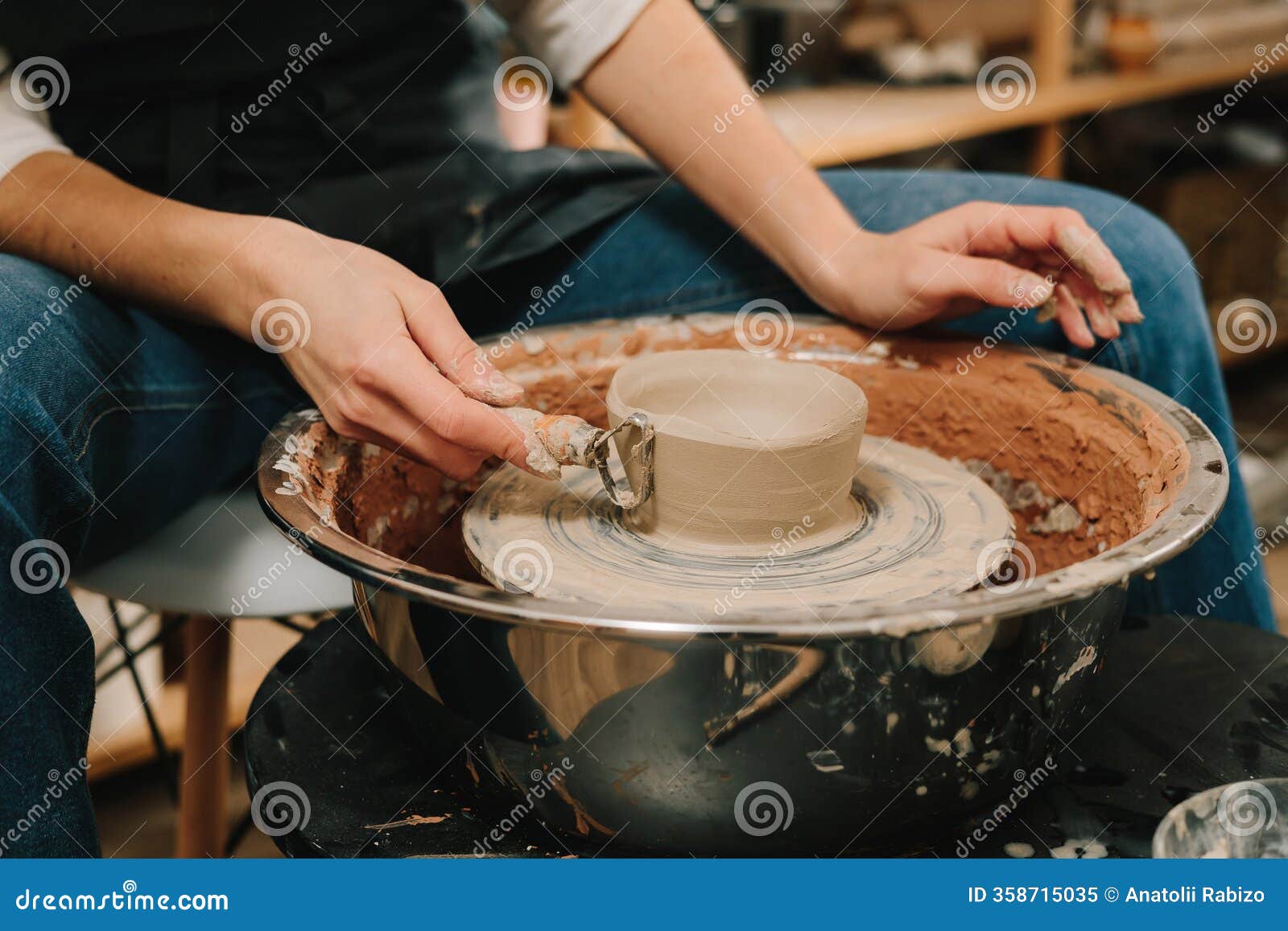 Artisan Forms Clay Pot with Potters Tool on the Spinning Wheel ...