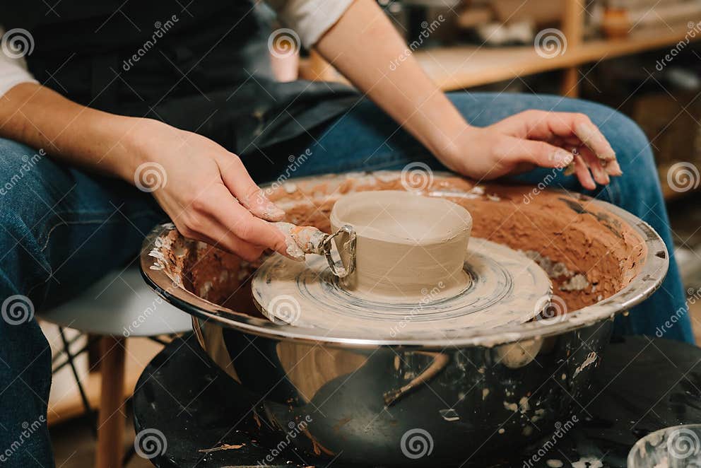 Artisan Forms Clay Pot with Potters Tool on the Spinning Wheel ...