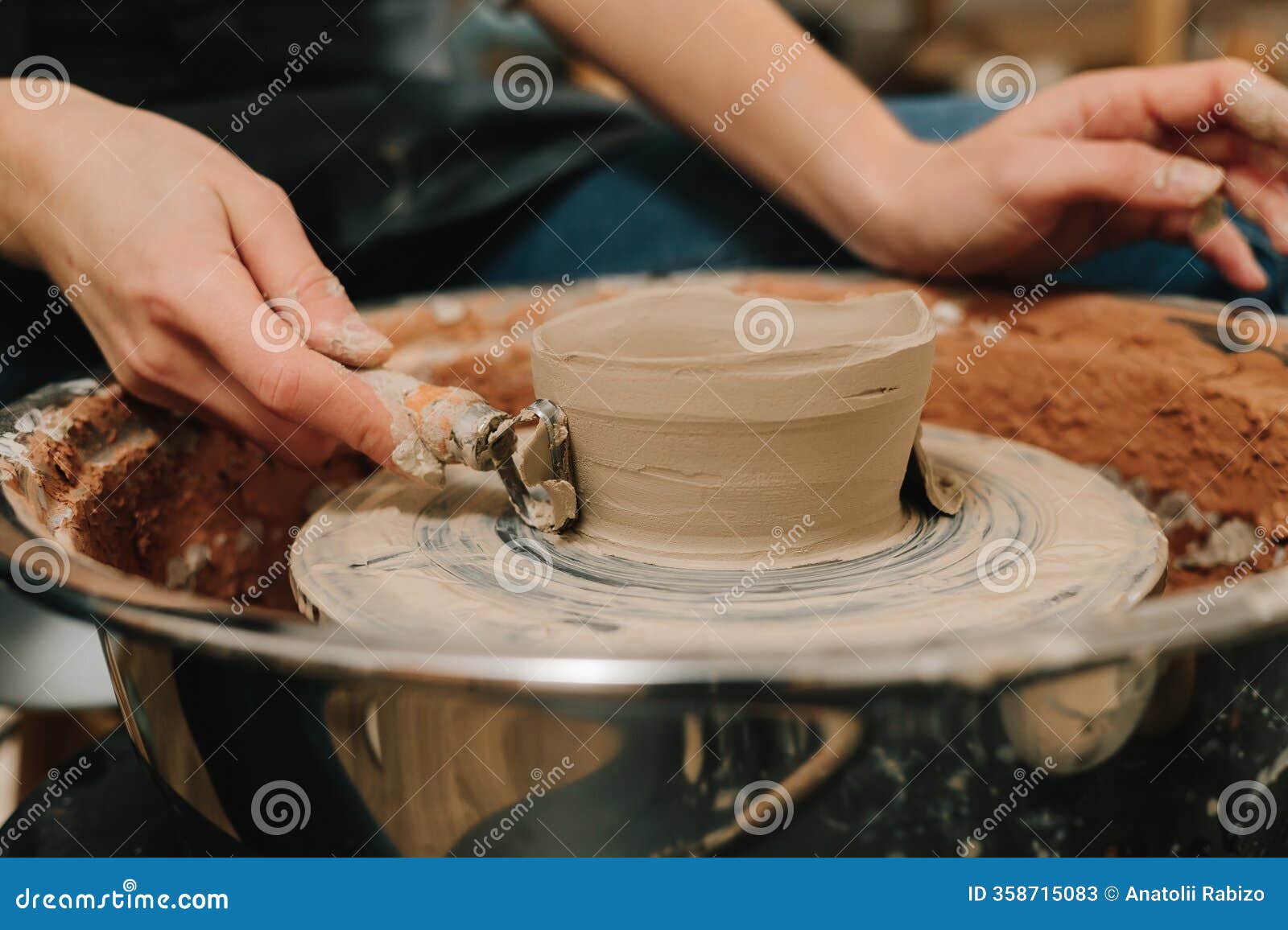 Artisan Forms Clay Pot with Potters Tool on the Spinning Wheel ...
