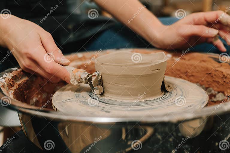 Artisan Forms Clay Pot with Potters Tool on the Spinning Wheel ...