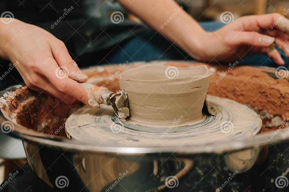 Artisan Forms Clay Pot with Potters Tool on the Spinning Wheel ...
