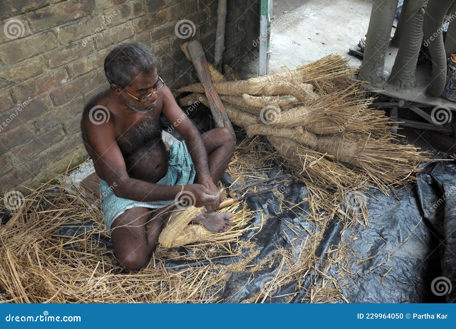An Artisan Preparing Structures with Clay and Bamboo Sticks. Editorial ...