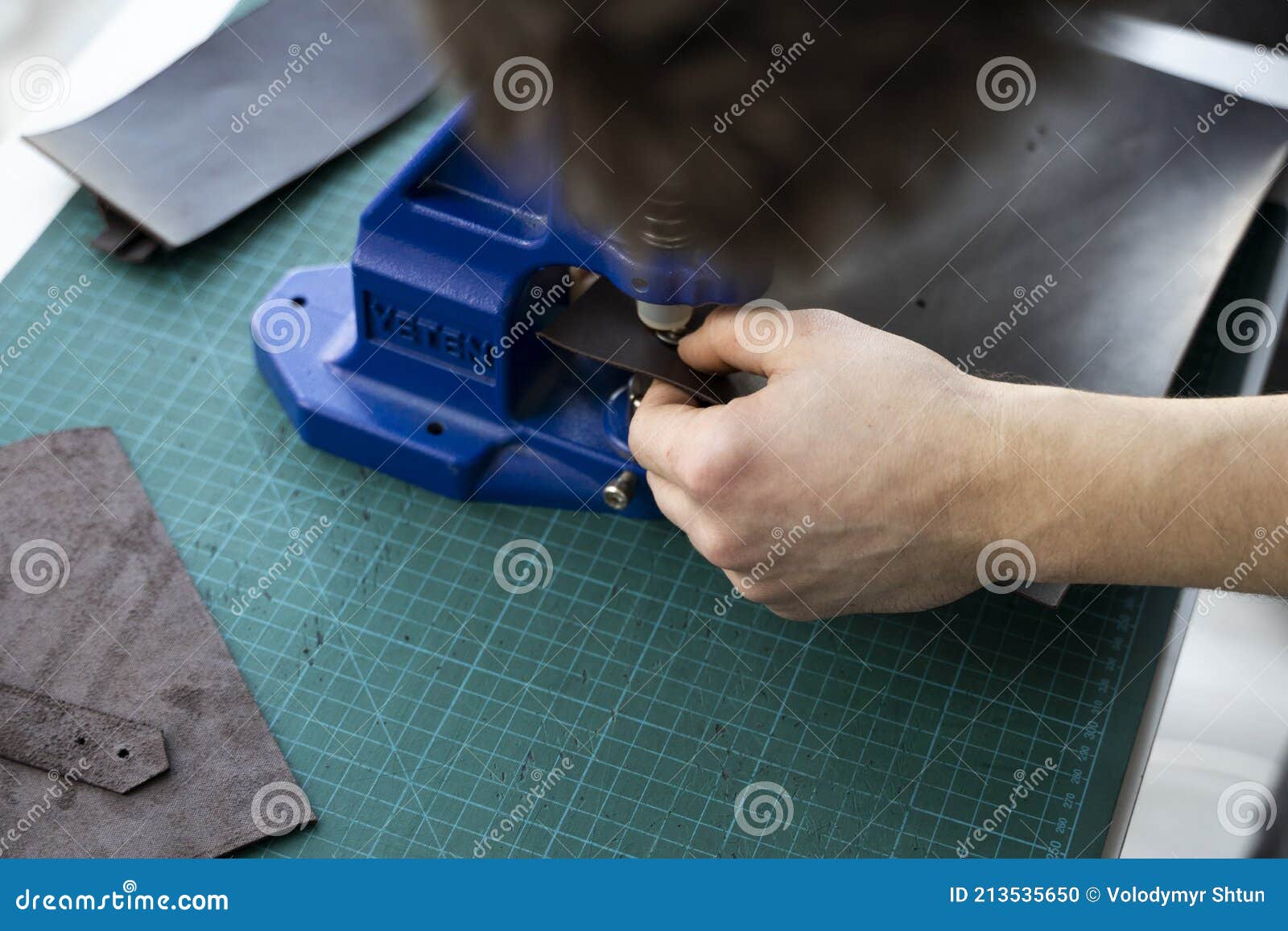 Artisan Using Hand Press for Setting Snaps in Leather for Makes a ...