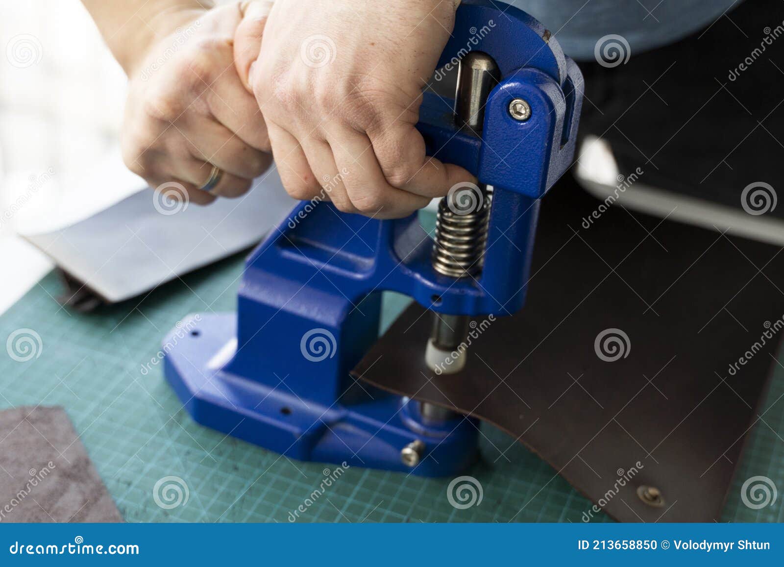 Artisan Using Hand Press for Setting Snaps in Leather for Makes a ...