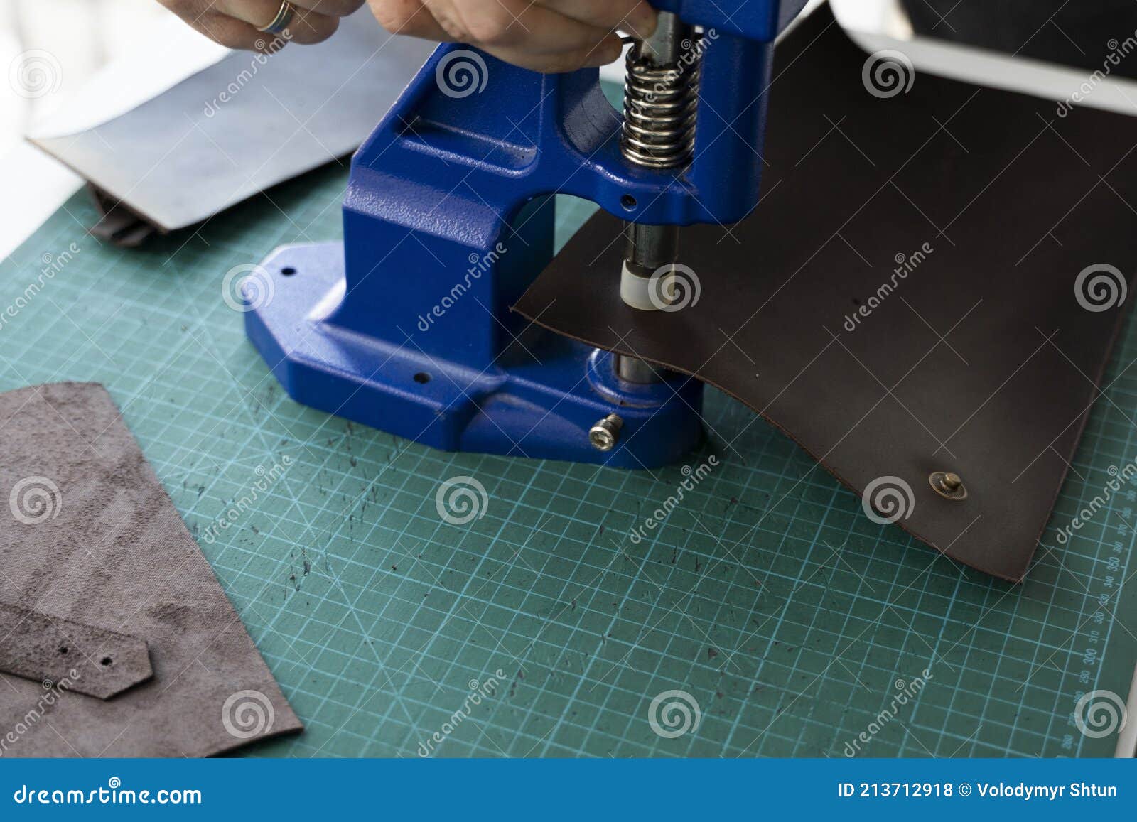 Artisan Using Hand Press for Setting Snaps in Leather for Makes a ...