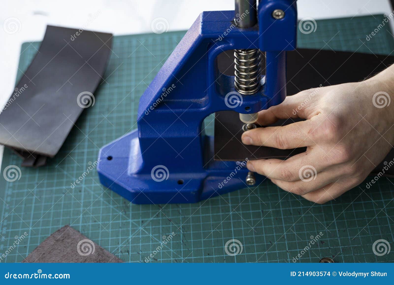 Artisan Using Hand Press for Setting Snaps in Leather for Makes a ...