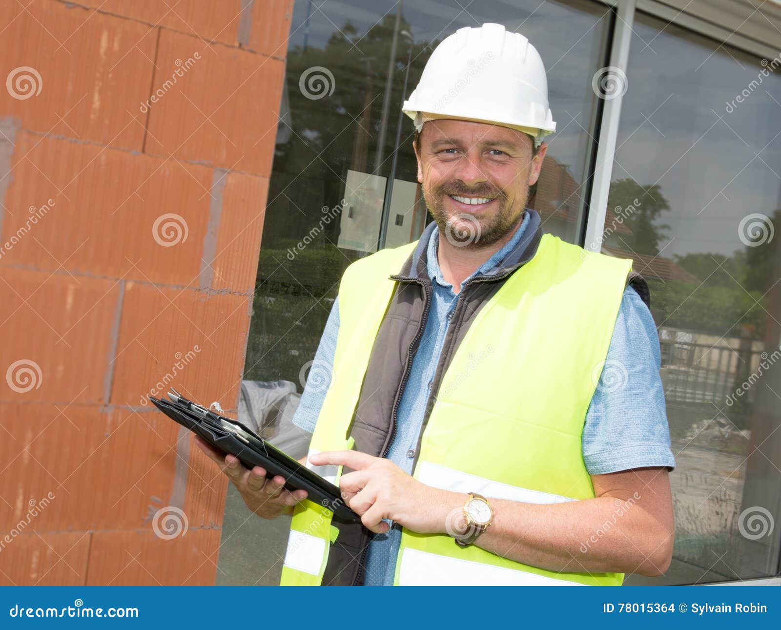 Artisan Using His Tablet Computer in a Construction Site Stock Photo ...