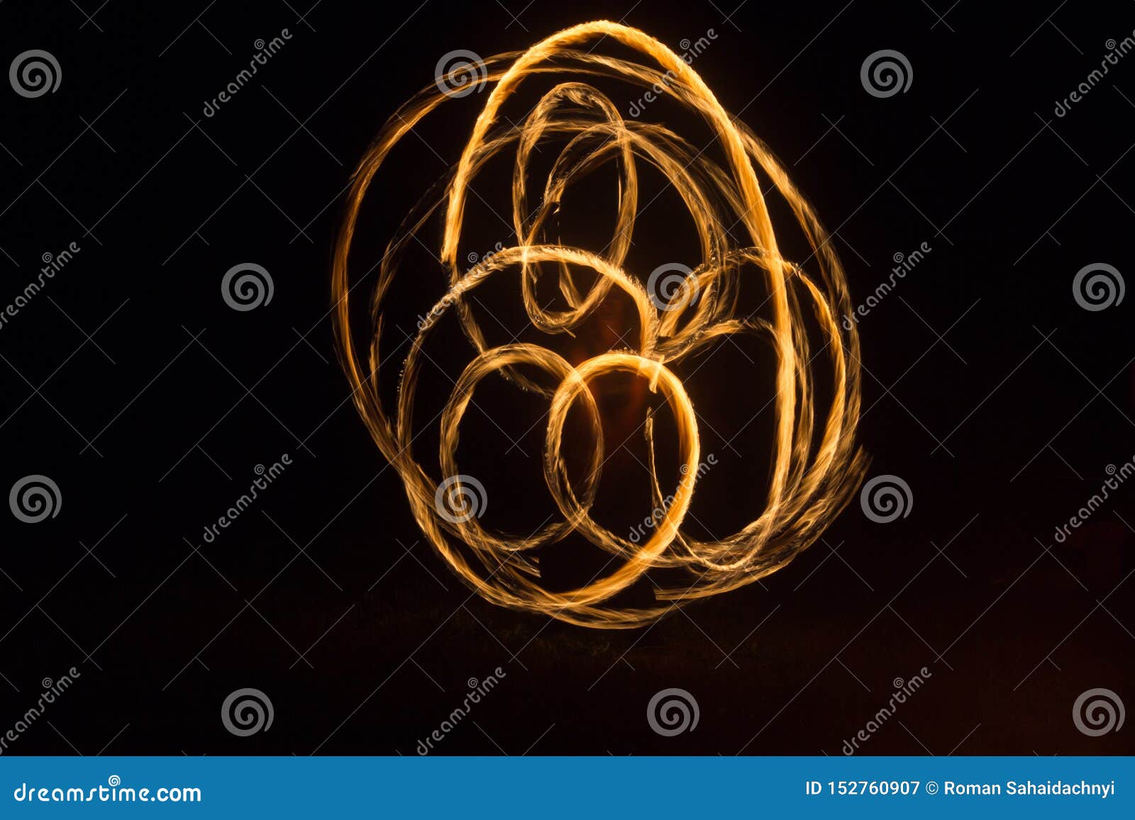 The Artist Shows a Fire Show at Night Spinning Torches, Circles of Fire ...