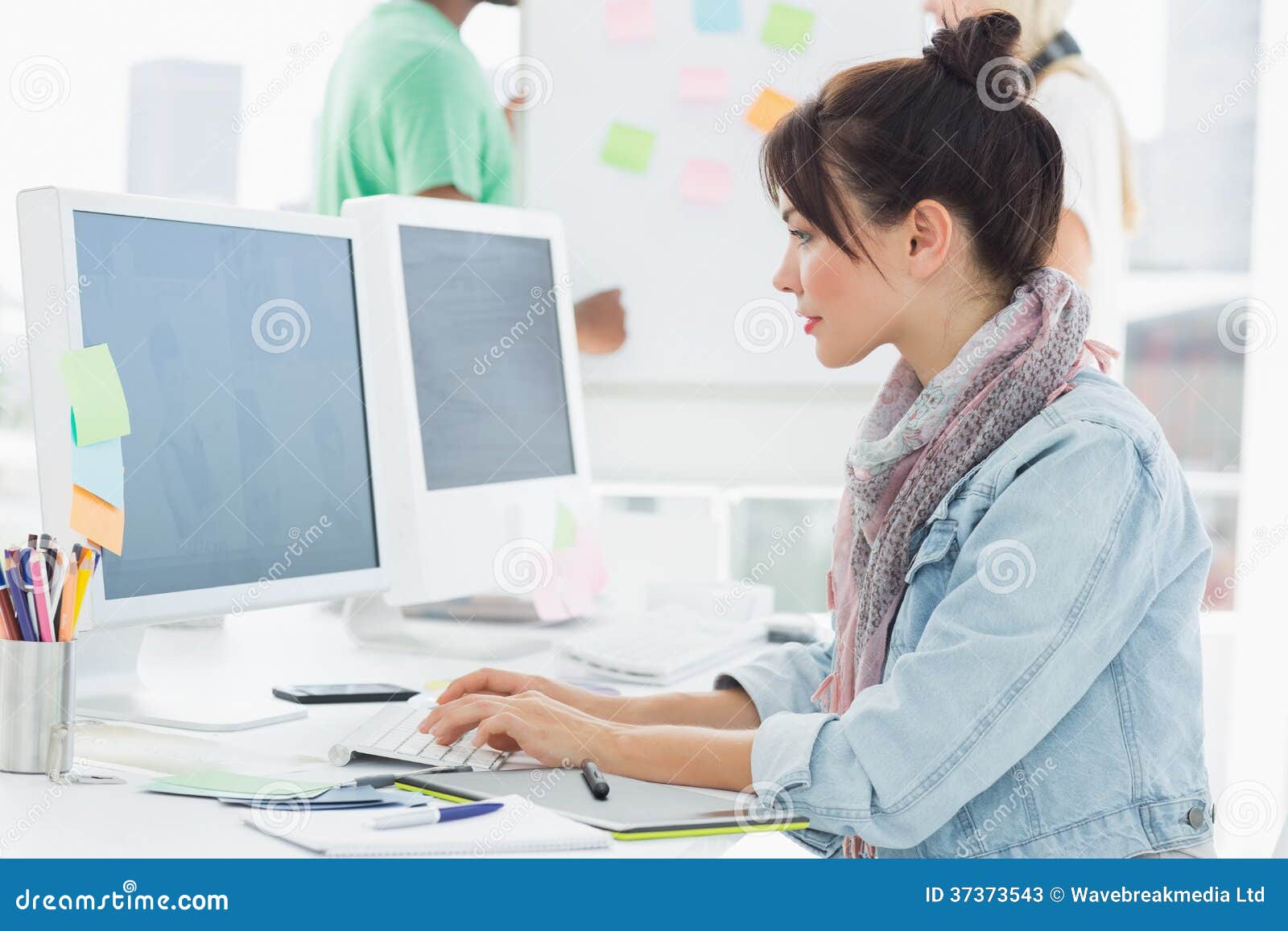 Artist Using Computer with Colleagues Behind at Office Stock Image ...