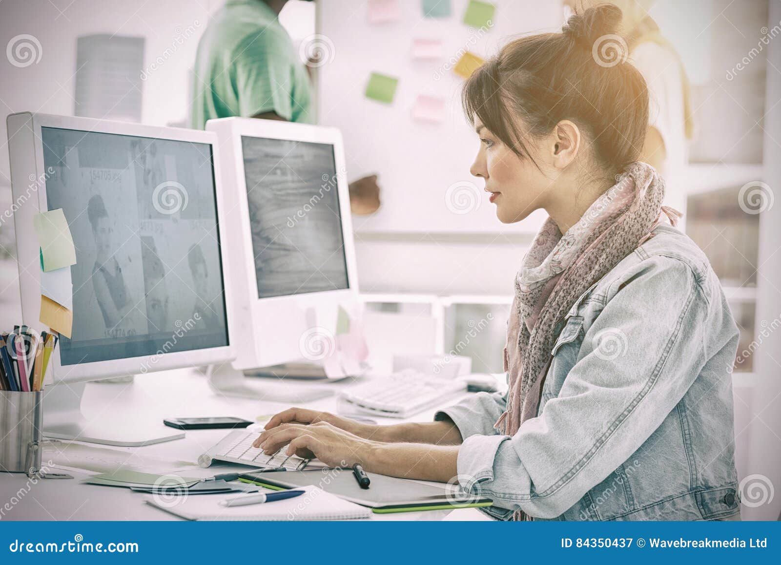 Artist Using Computer with Colleagues Behind at Office Stock Image ...