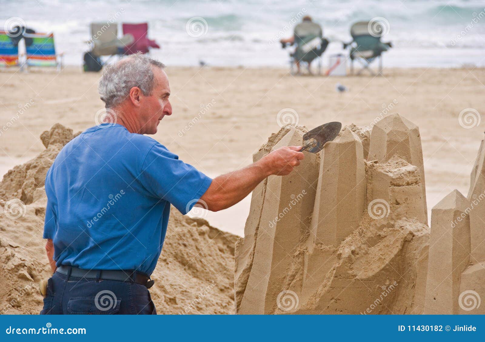 Artist working on beach editorial photography. Image of sculptor - 11430182