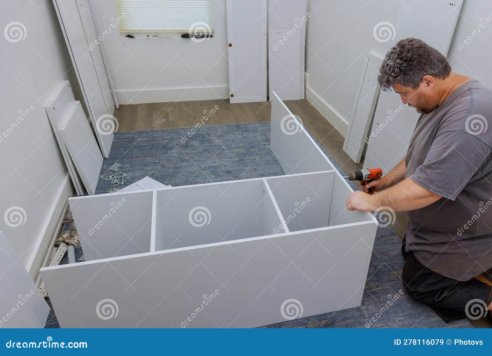 As the Carpenter Was in the Process of Assembling Furniture Closet ...